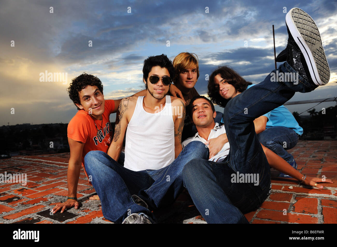 Portrait of young trendy group of male friends having fun Stock Photo ...