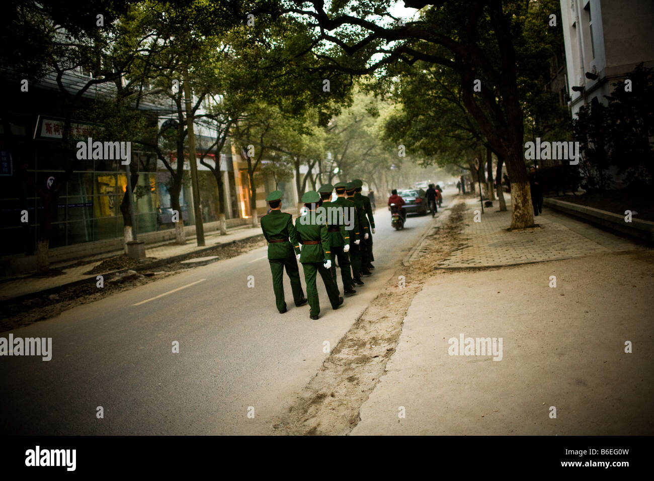 Soldiers walk in a line through a new construction area in Nanchang ...