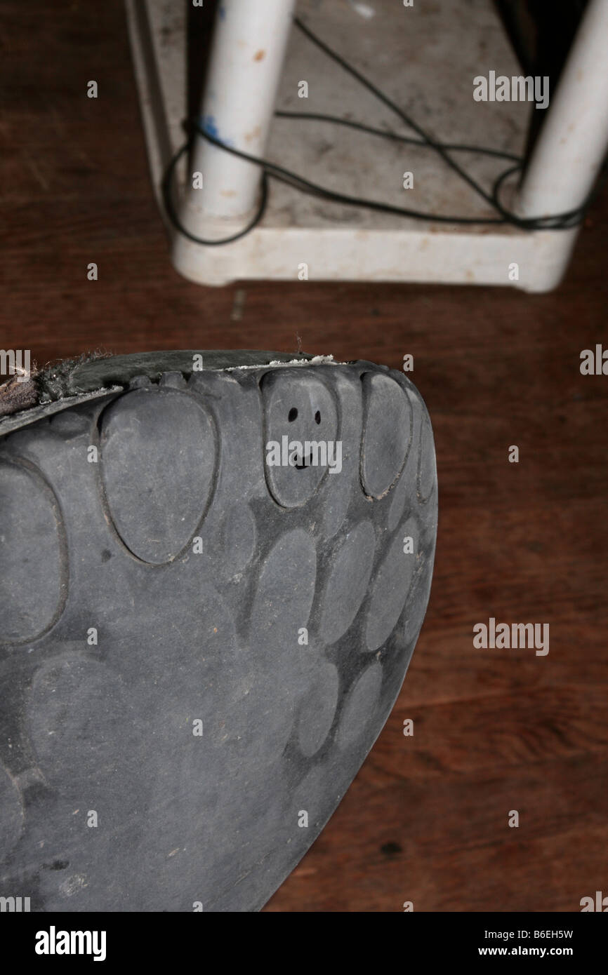 Smiley face drawn on sole of shoe Stock Photo - Alamy