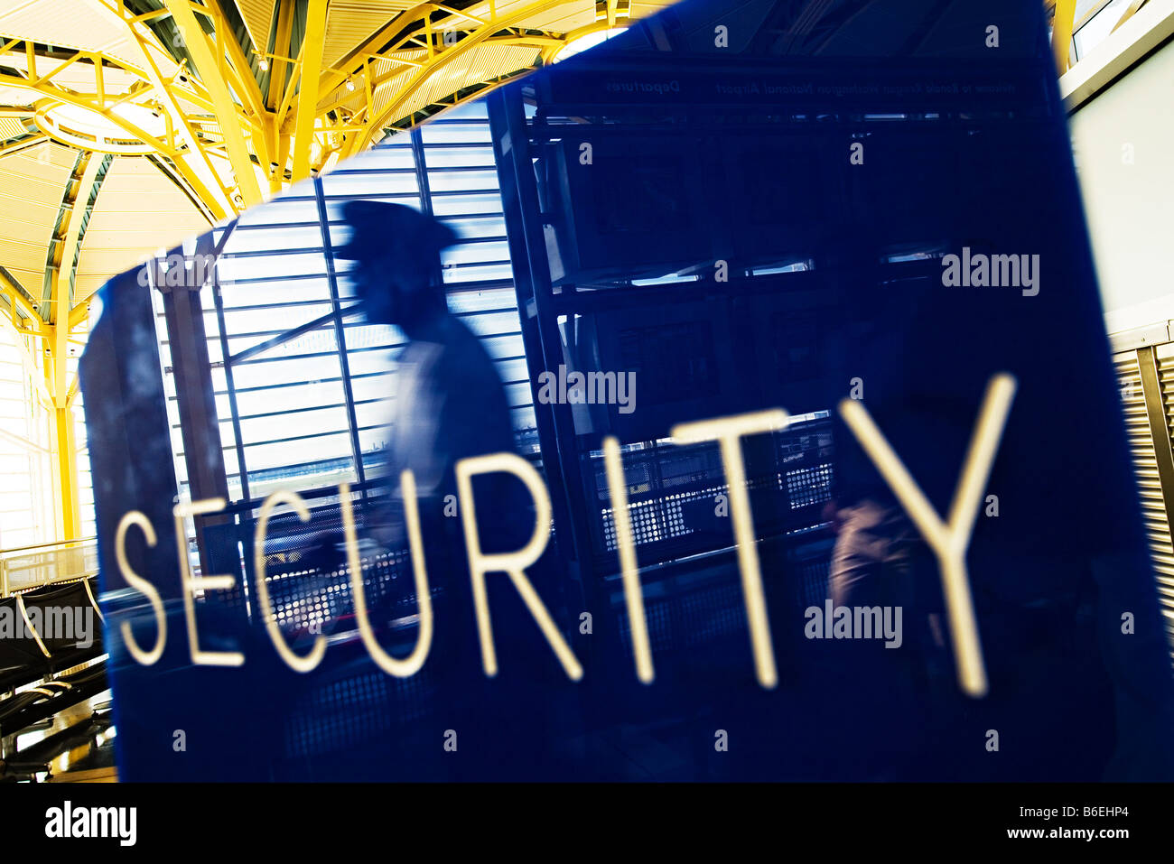A TSA security guard walks by a Security sign at Ronald Reagan National ...