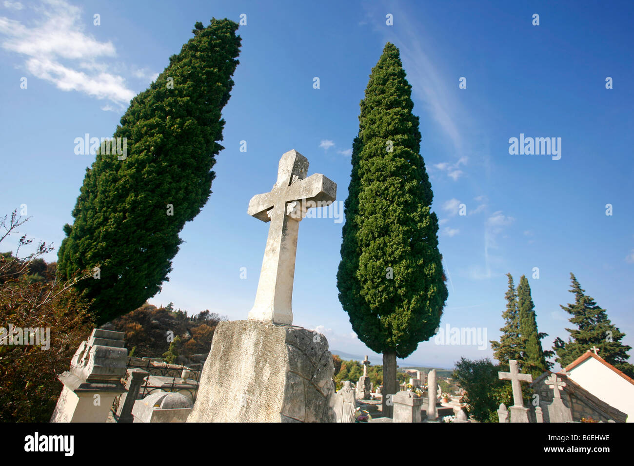 tombstone crosses on blue mediterranean sky with cypresses Stock Photo ...