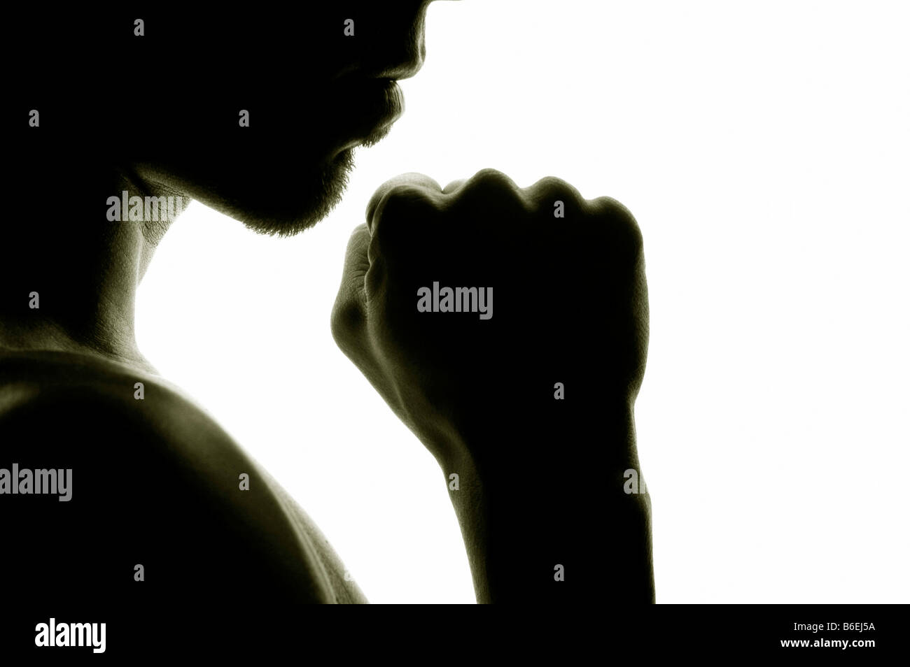 Man's fist and chin in silhouette Stock Photo - Alamy