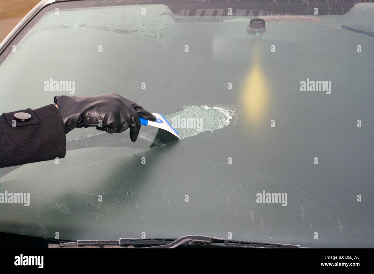 Woman scrape ice windscreen hi-res stock photography and images - Alamy