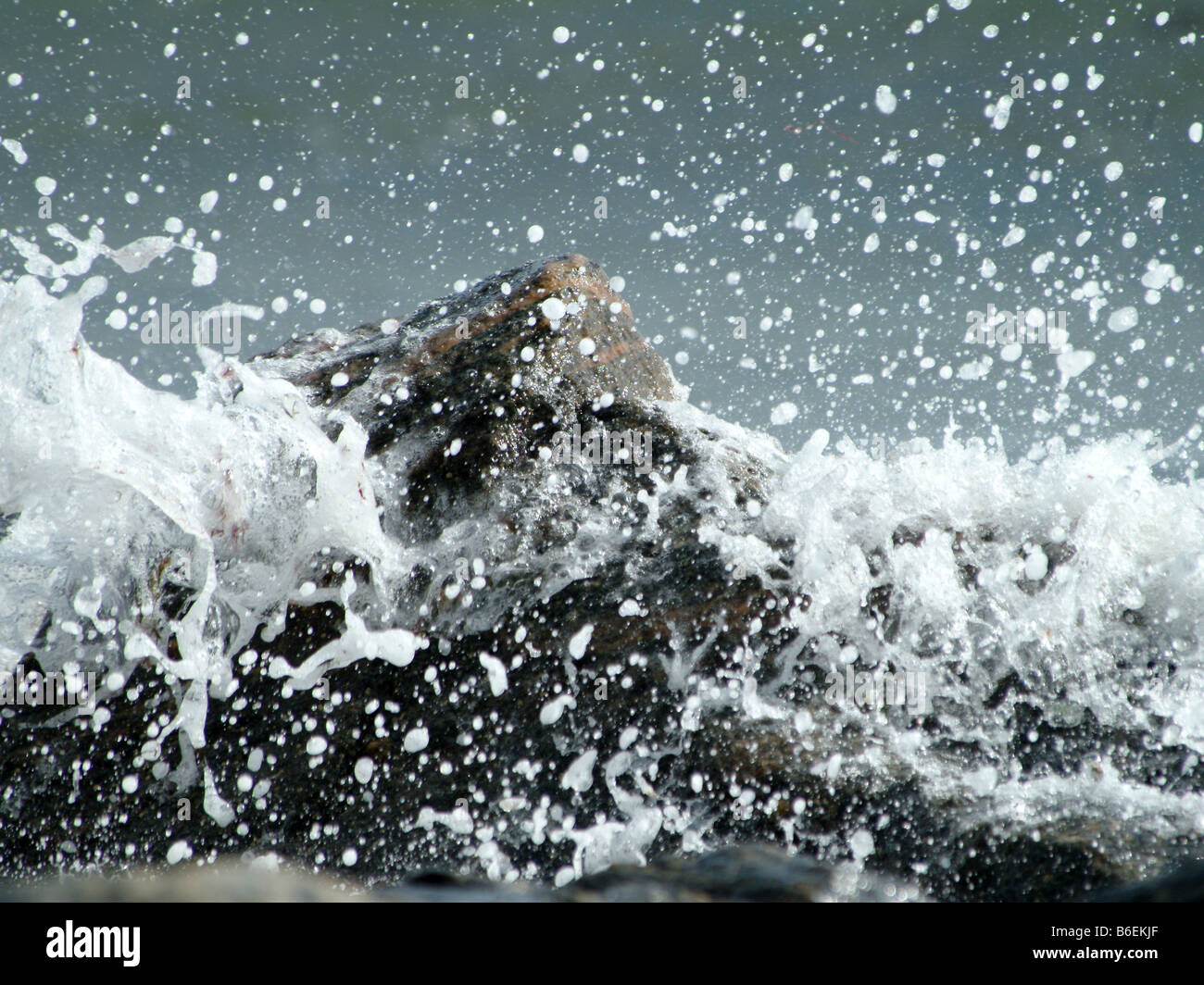 Water splash and rock Stock Photo - Alamy