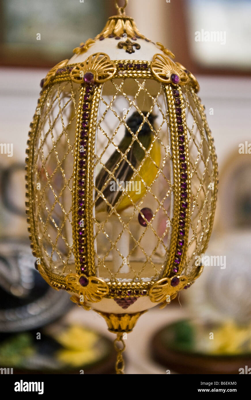 A miniature song bird within a carved, decorated egg Stock Photo - Alamy