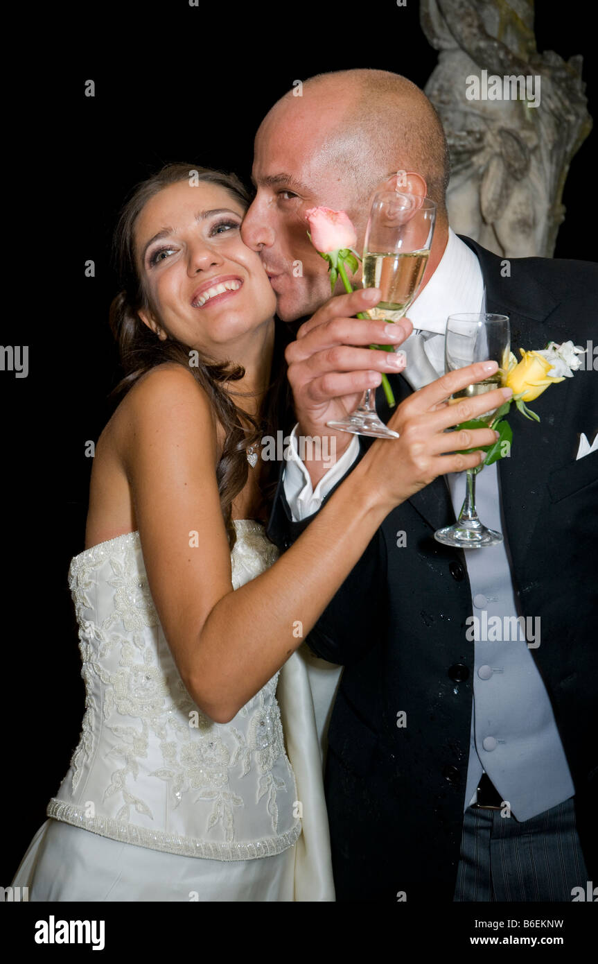 Bride and groom kissing and toasting at Italian wedding Italy Stock ...