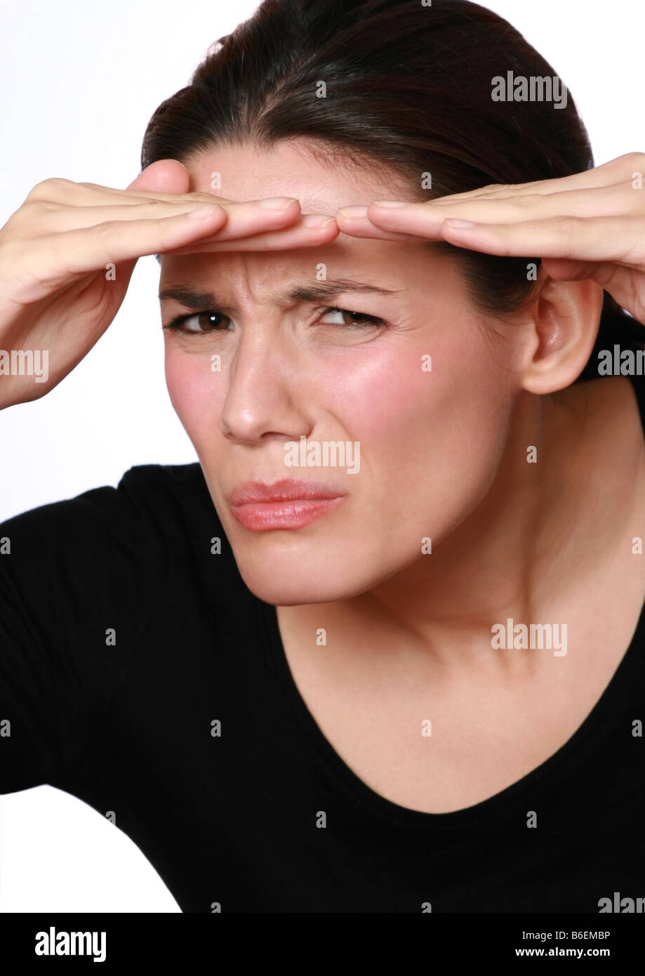 Young woman using her hands to see more clearly Stock Photo - Alamy