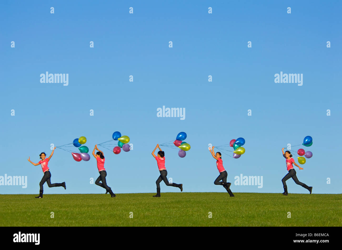 A sequence image of a young girl (11) running happily across green ...