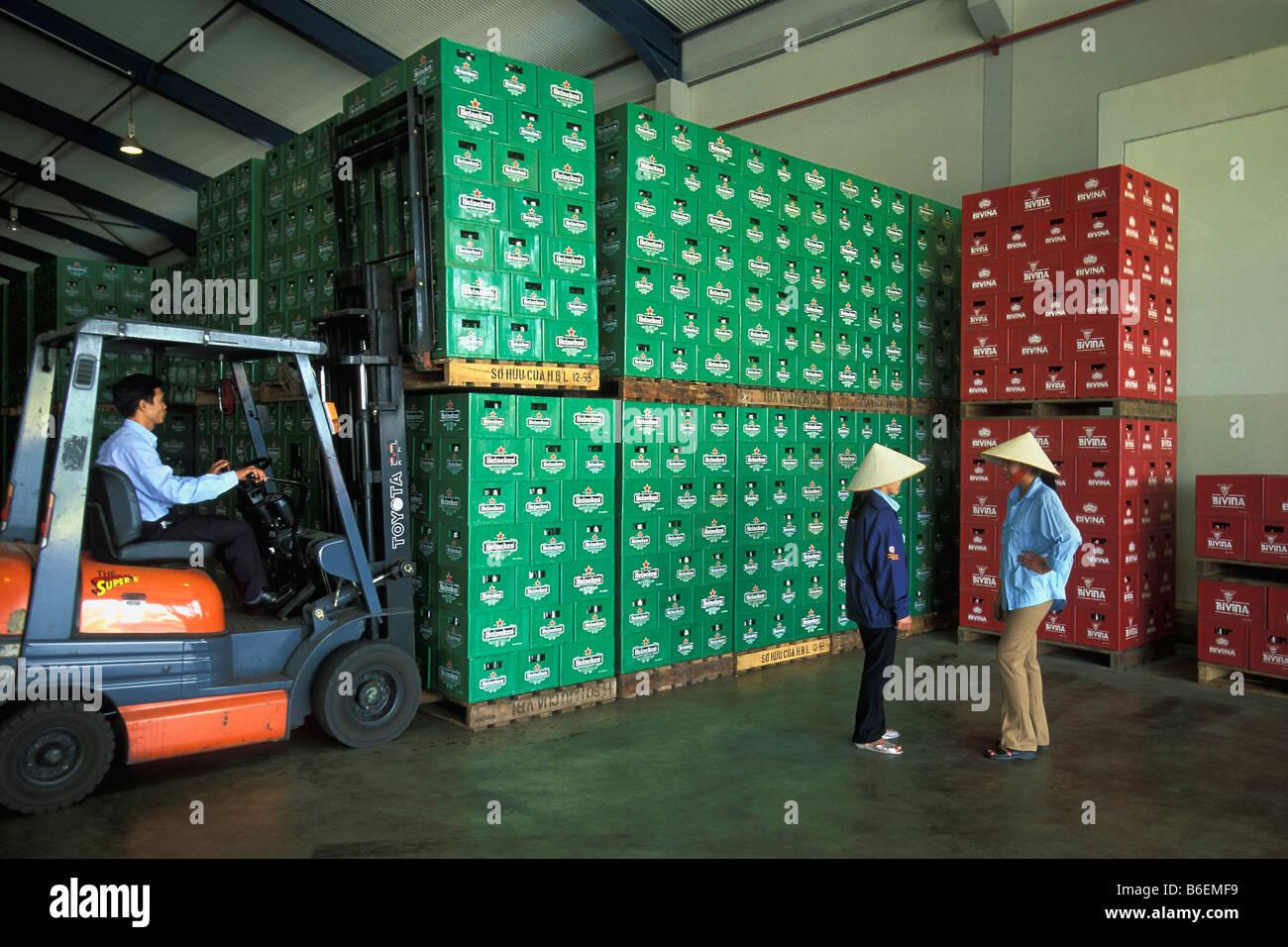 Vietnam. Hanoi. Women and men working in Heineken breweries ...