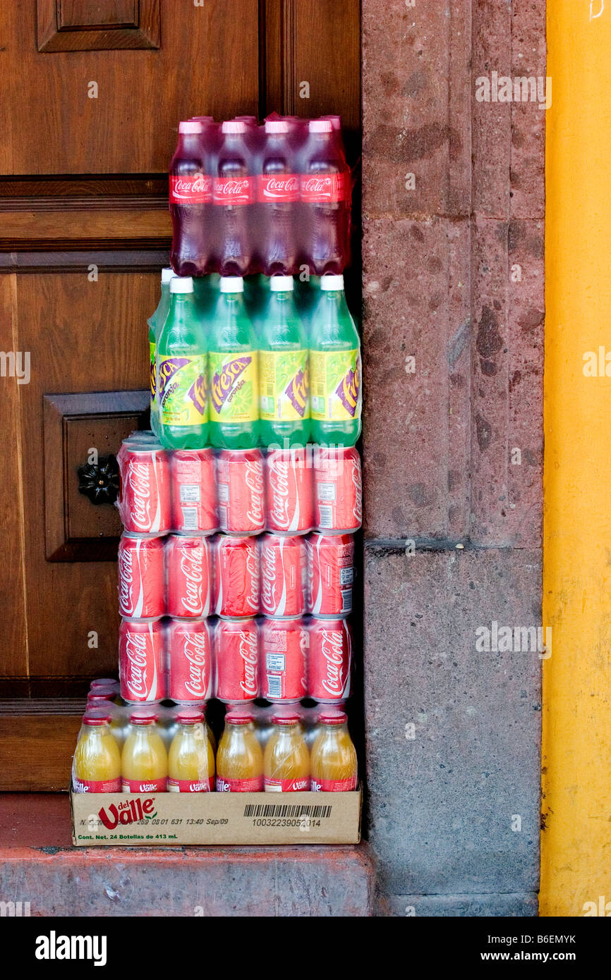 Bottles of soda wrapped in plastic outside the door of a market in San ...