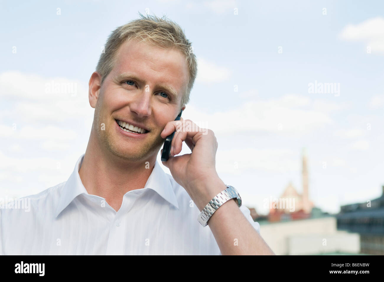 Guy speaking on his cellphone on a balcony Stock Photo - Alamy