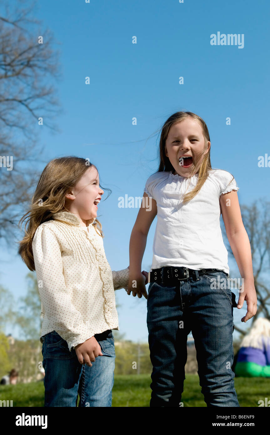 Sisters holding hands Stock Photo - Alamy