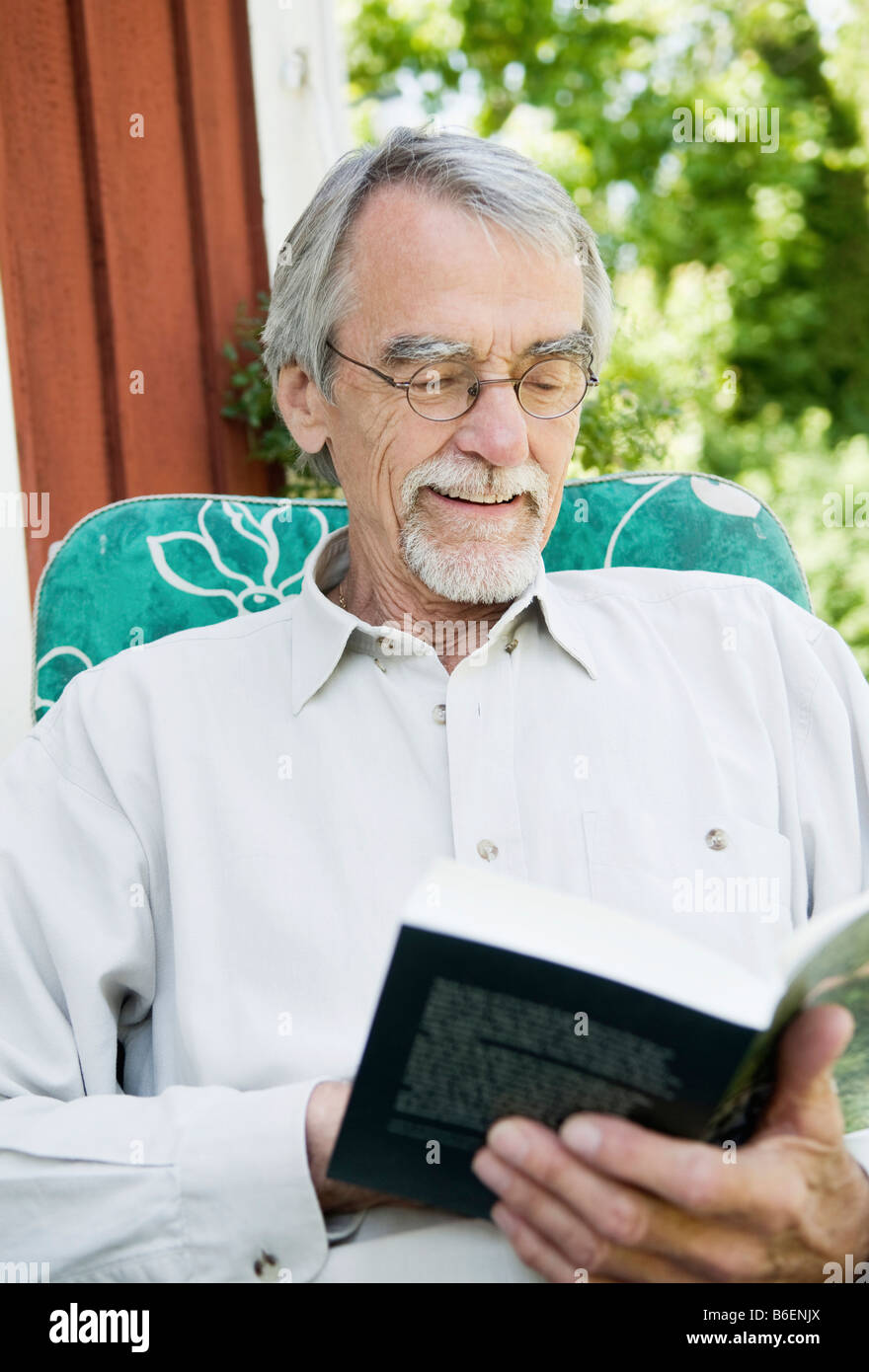 Man reading a book outdoor Stock Photo - Alamy