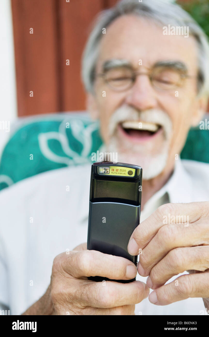 Man laughing at text message Stock Photo - Alamy