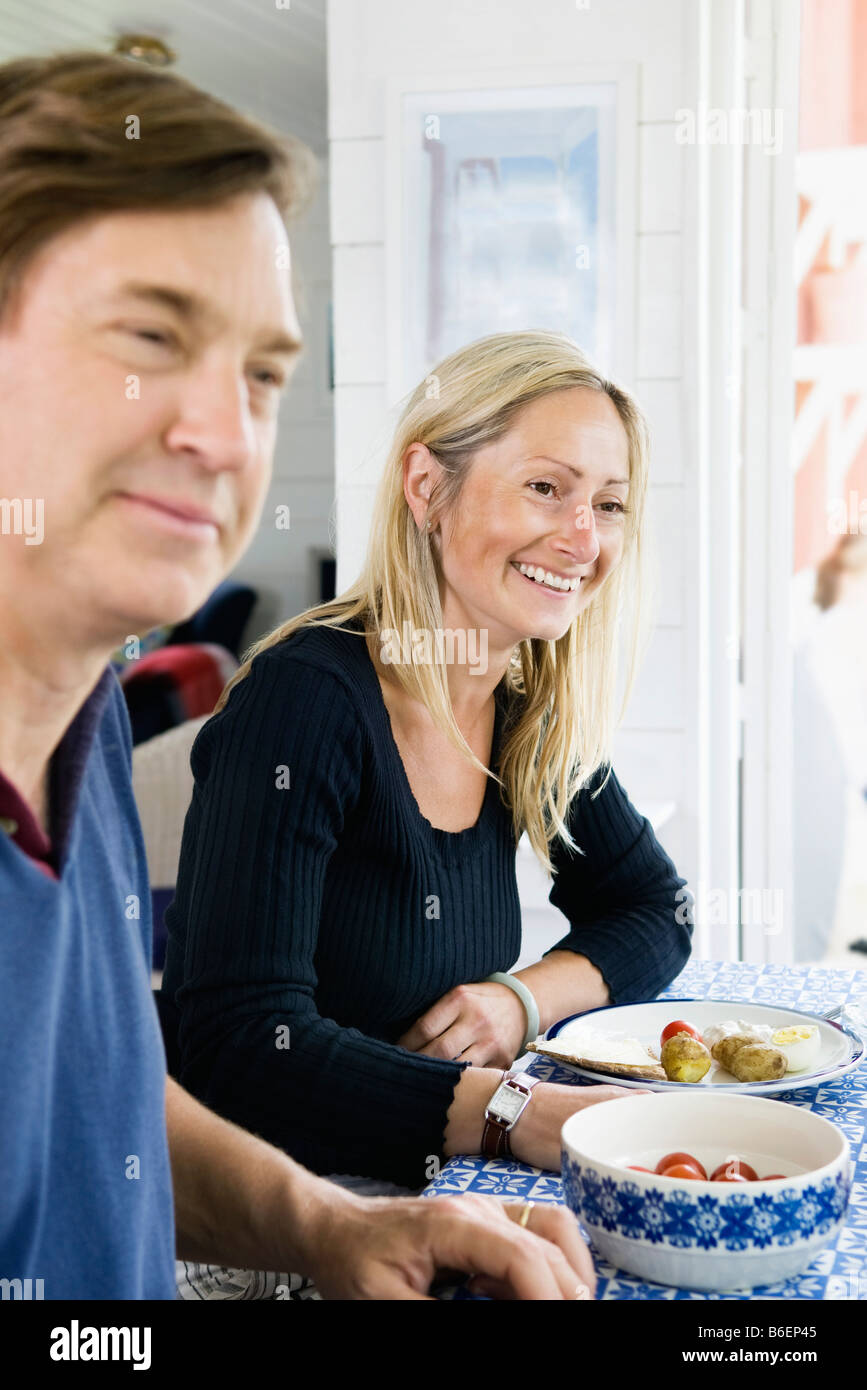 Two people by table Stock Photo - Alamy