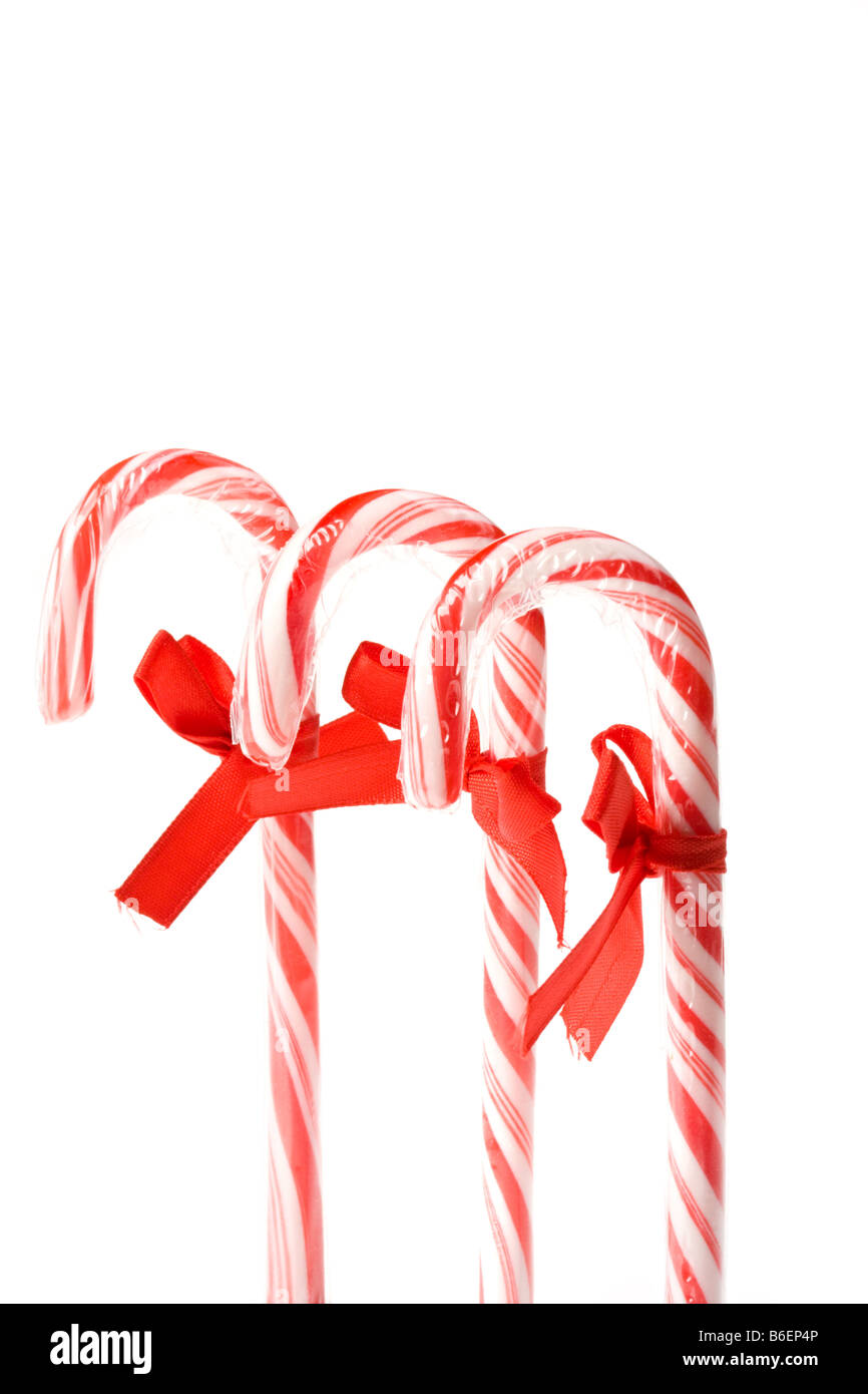 three candy canes isolated on white Stock Photo - Alamy