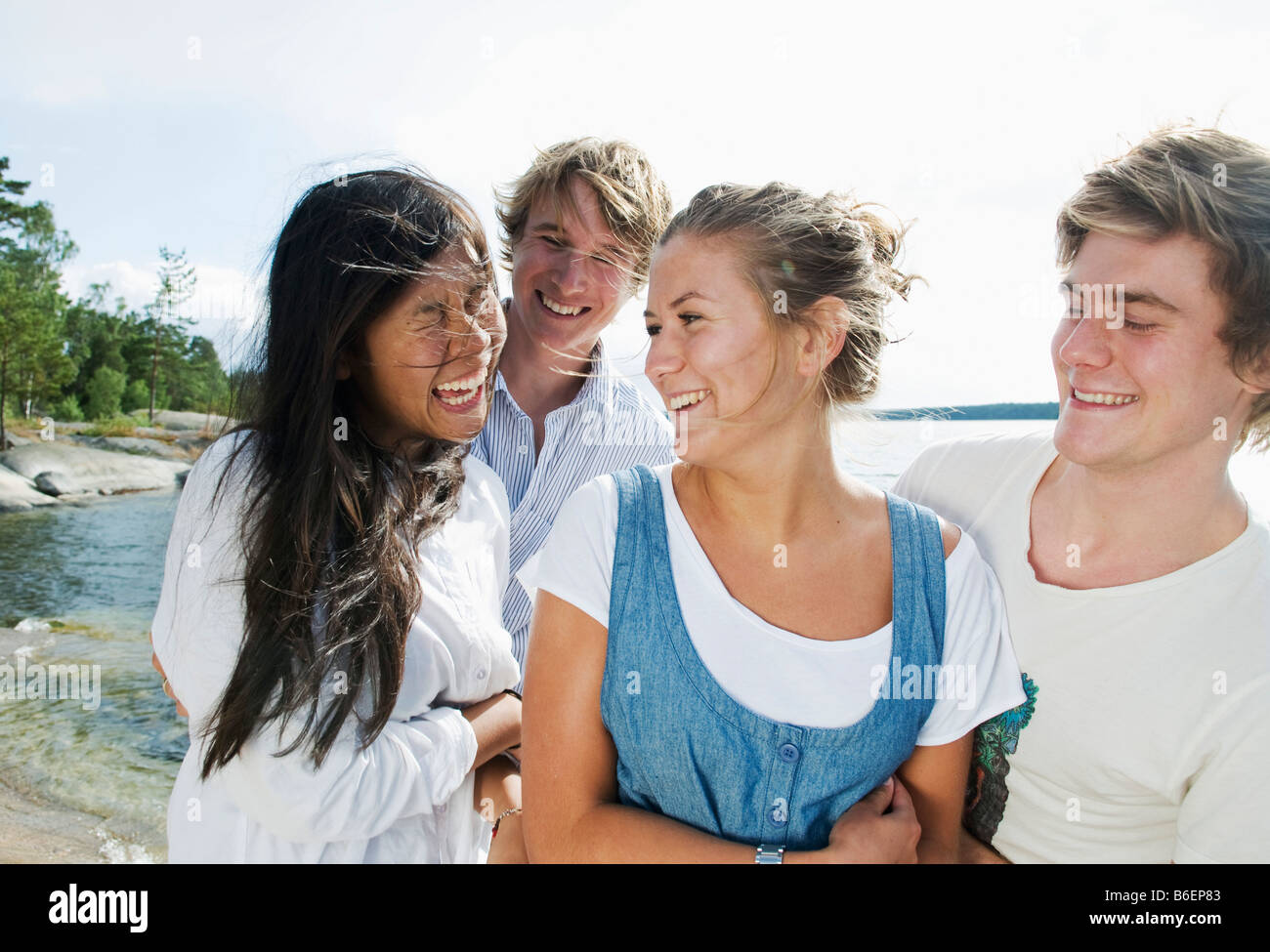 Happy friends by lake Stock Photo - Alamy