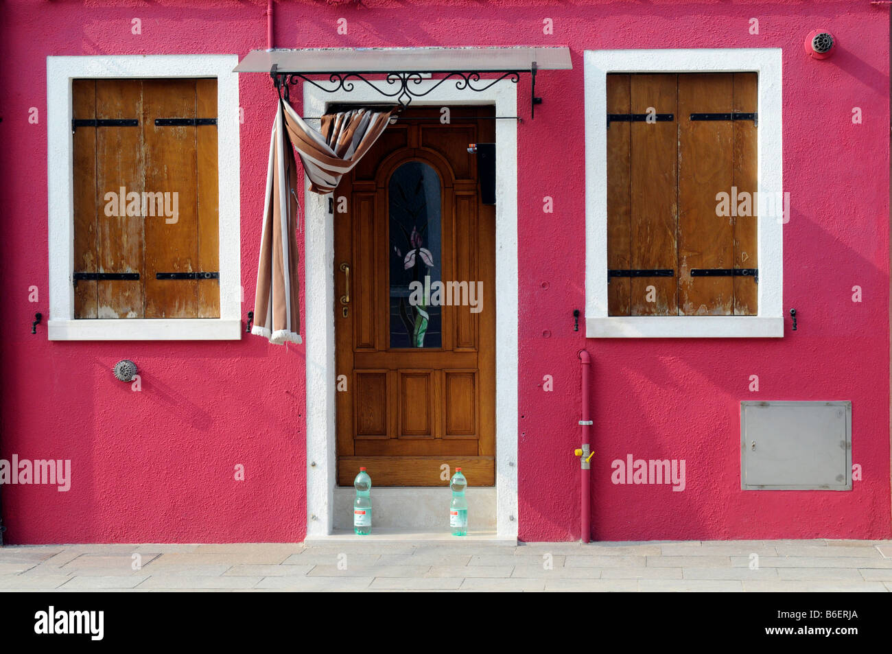 Colorfully painted building facade and entrance in Burano, Venice ...