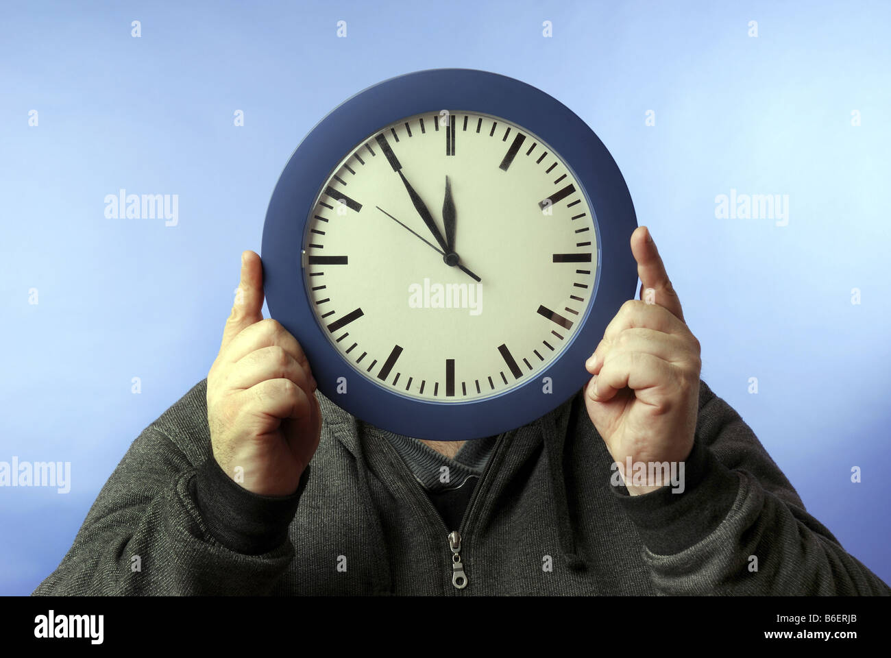man holding clock in front of his face Stock Photo - Alamy