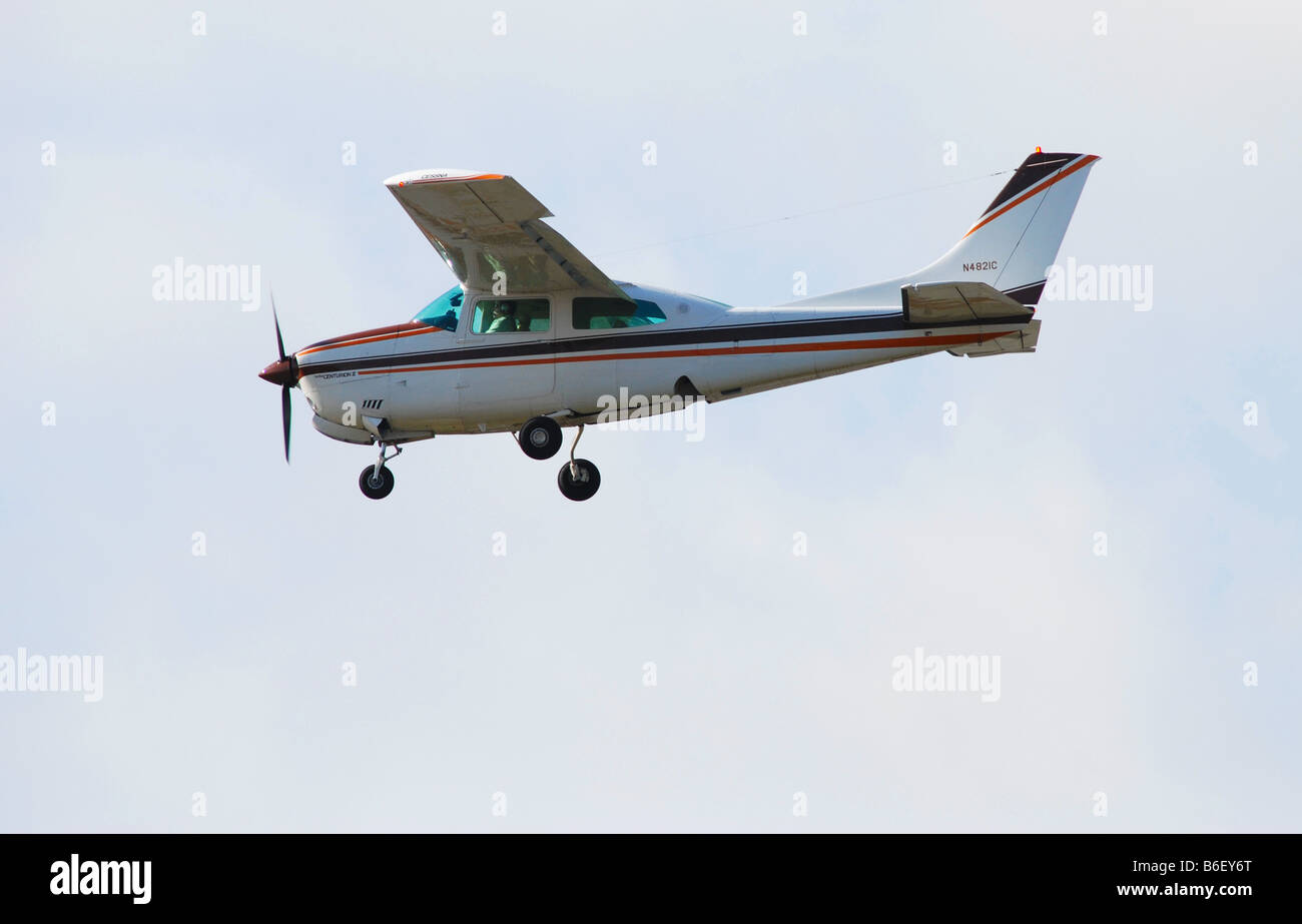 Small propeller plane flying through the sky Stock Photo - Alamy