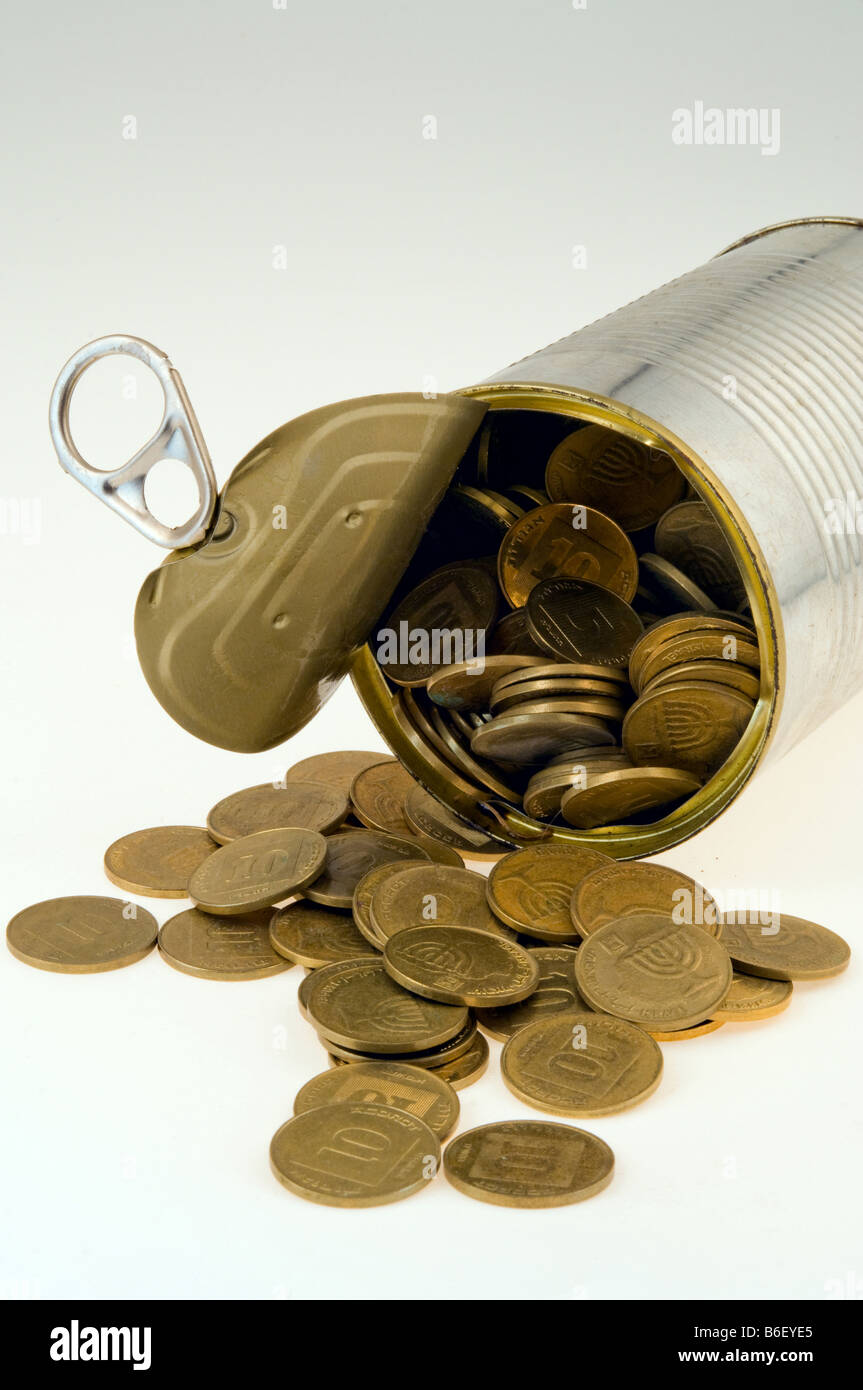 coins poured from tin bank Stock Photo - Alamy