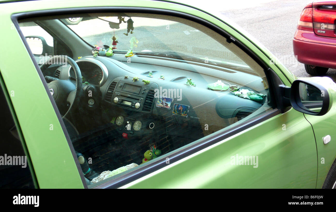 green car with with many frogs on dashboard Stock Photo - Alamy