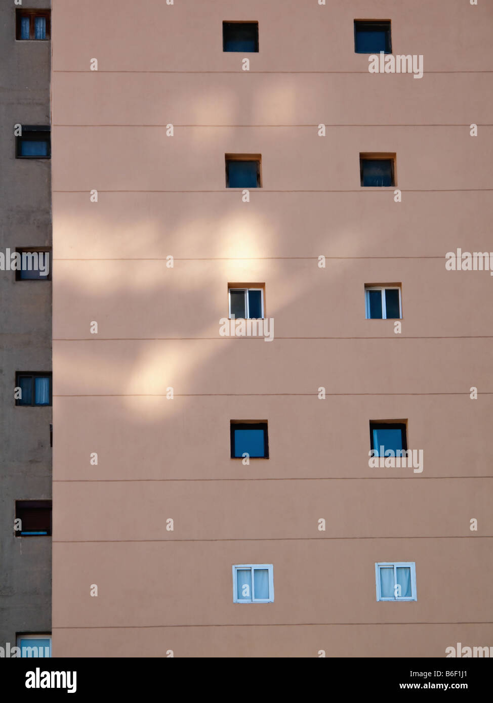 Windows in an apartment block wall Stock Photo - Alamy