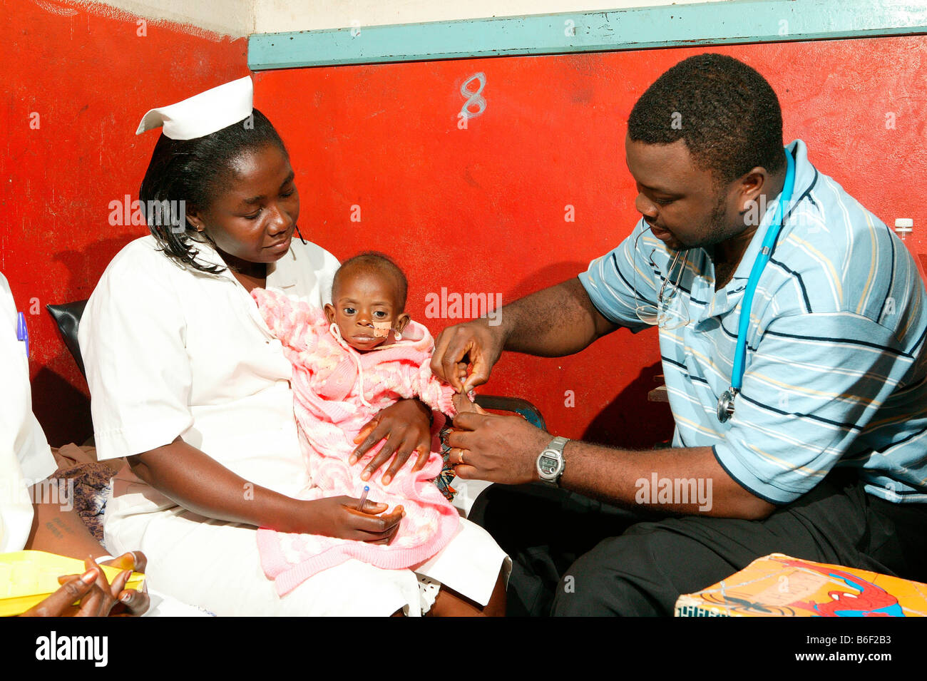 Examination and treatment of an AIDS/HIV infant in a hospital in ...