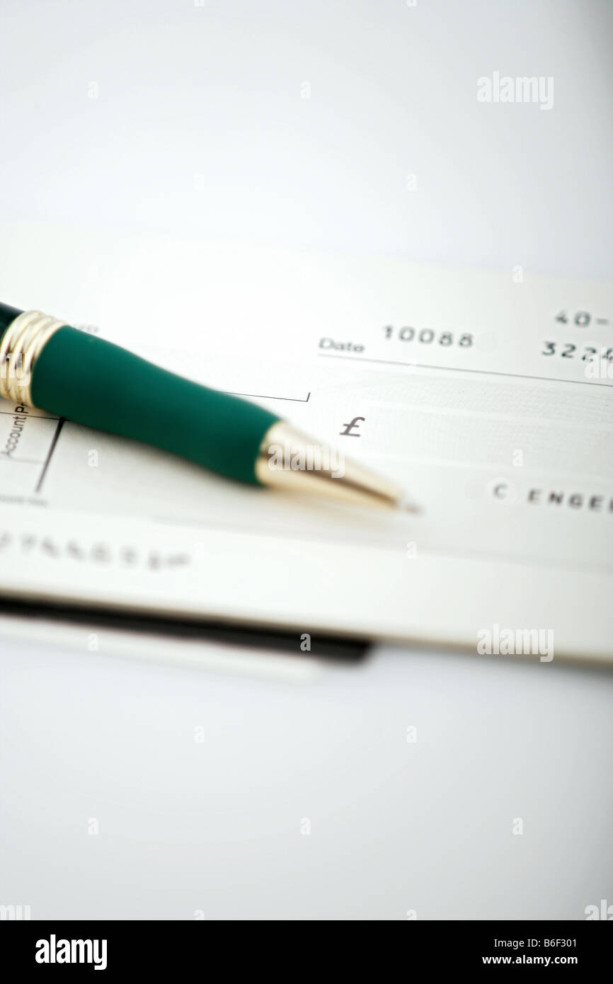 A signed cheque or check on a white table Stock Photo - Alamy