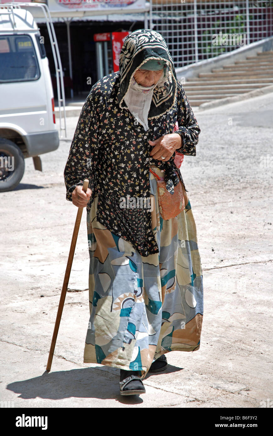 Old woman with walking stick and downcast view hi-res stock photography ...