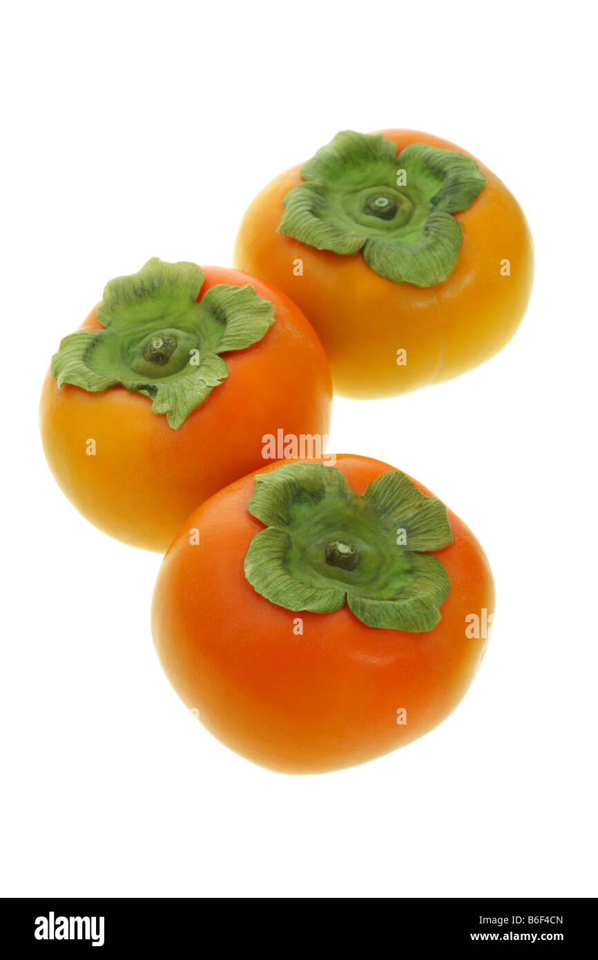 Three fresh persimmon fruits on white background Stock Photo - Alamy