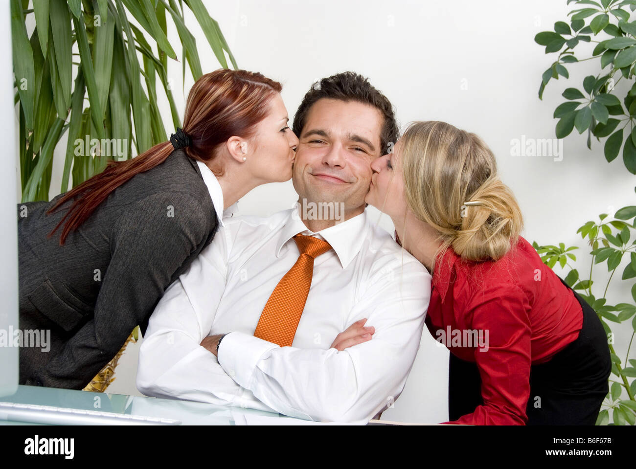 secretaries kissing boss Stock Photo - Alamy