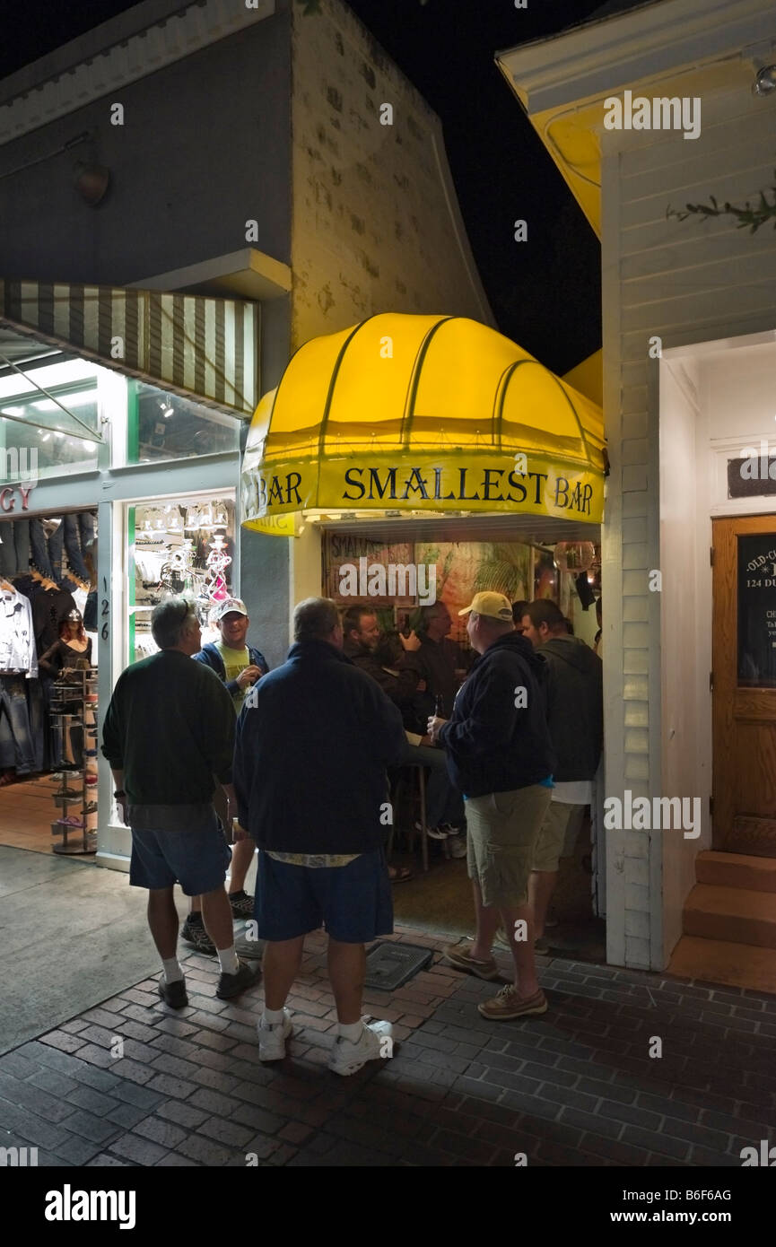 Group of men standing outside the "Smallest Bar" on Duval Street at ...