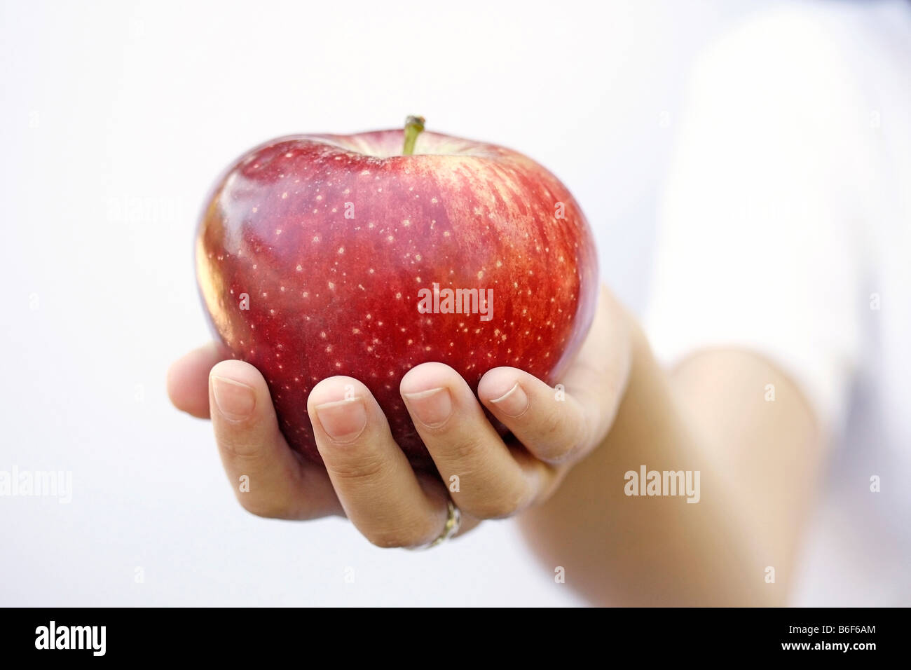 Apple on hand Stock Photo - Alamy