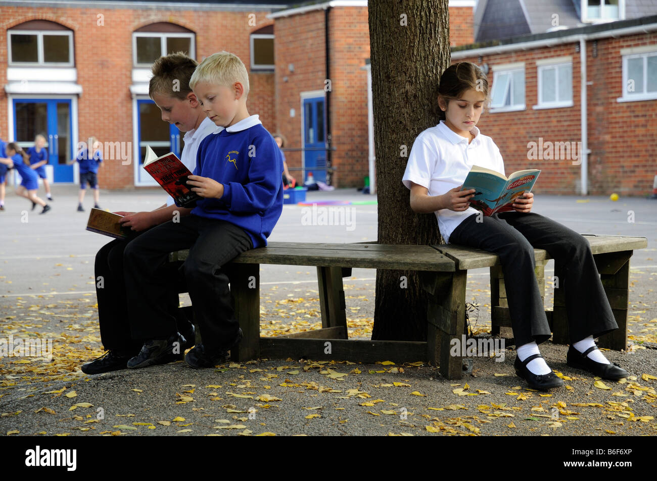 Children reading in a primary school playground Stock Photo - Alamy