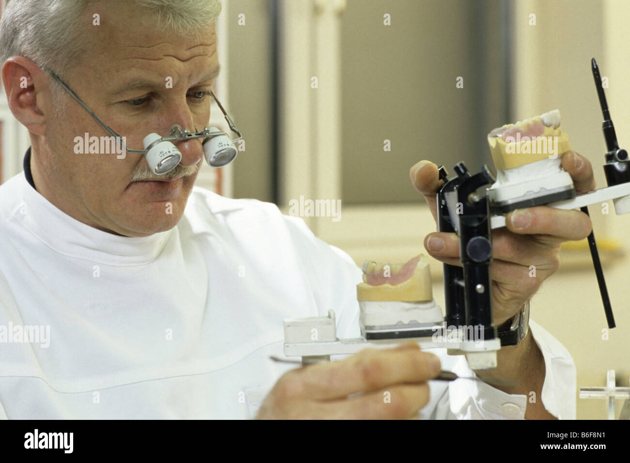 dentist adjusting dentures Stock Photo - Alamy