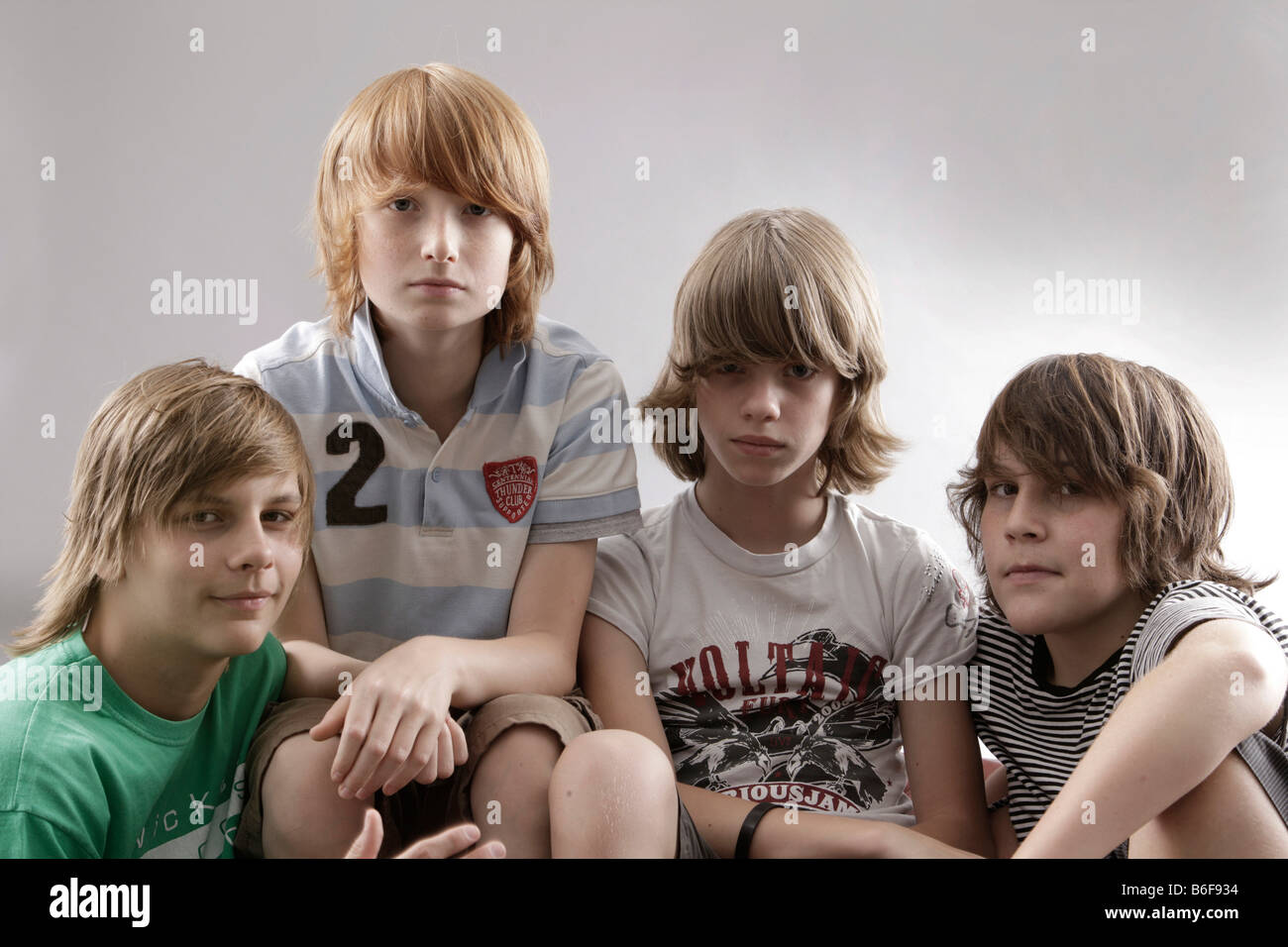 Four boys looking into the camera Stock Photo - Alamy