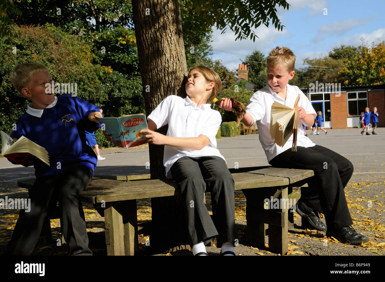 Schoolboys bully a schoolgirl classmate by pulling her hair in the ...