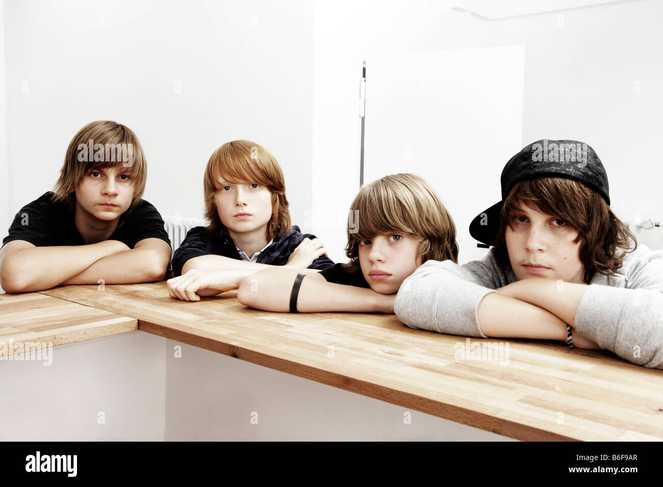 Four boys at a counter Stock Photo - Alamy