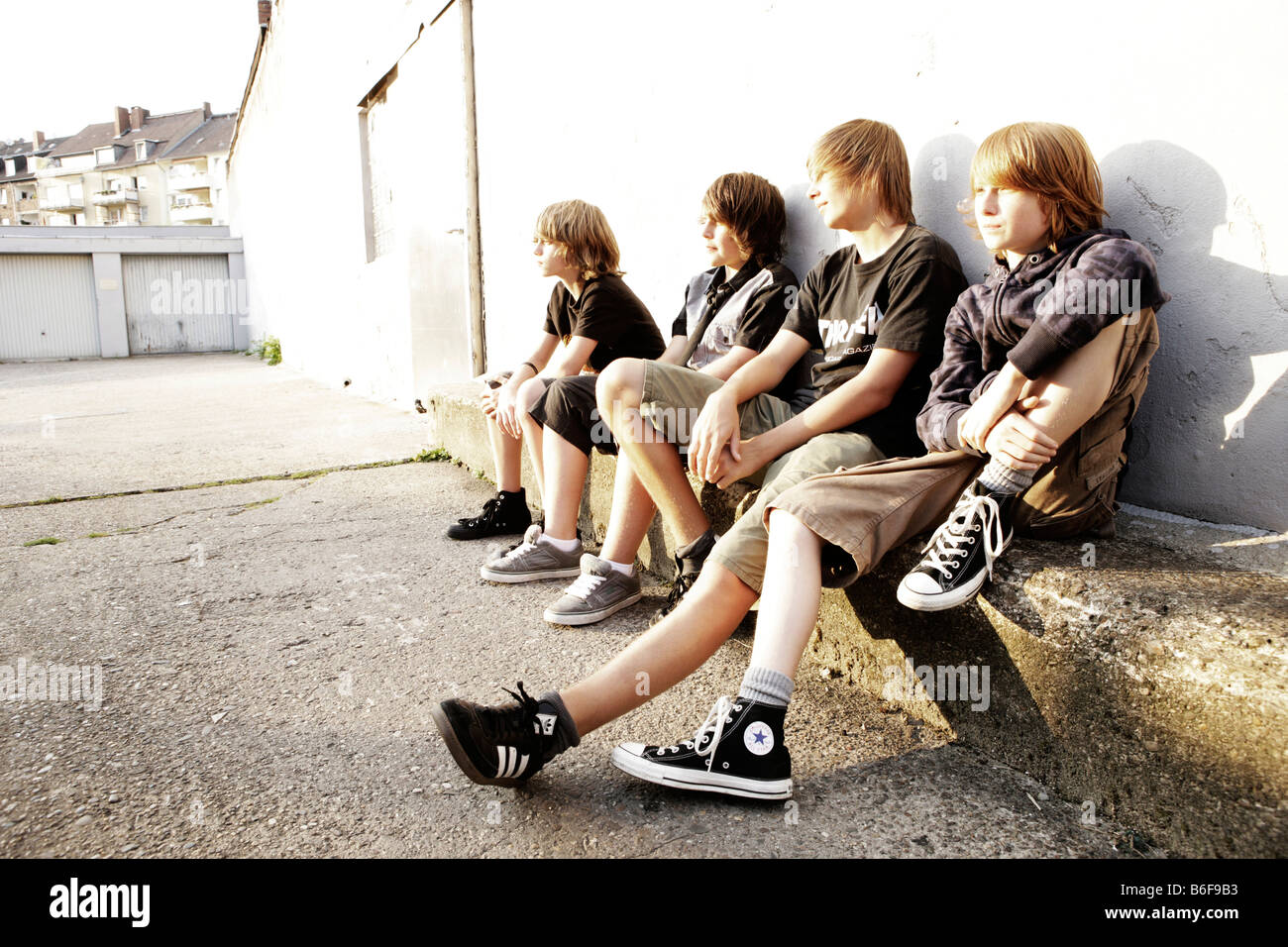 Four boys in a backyard Stock Photo - Alamy