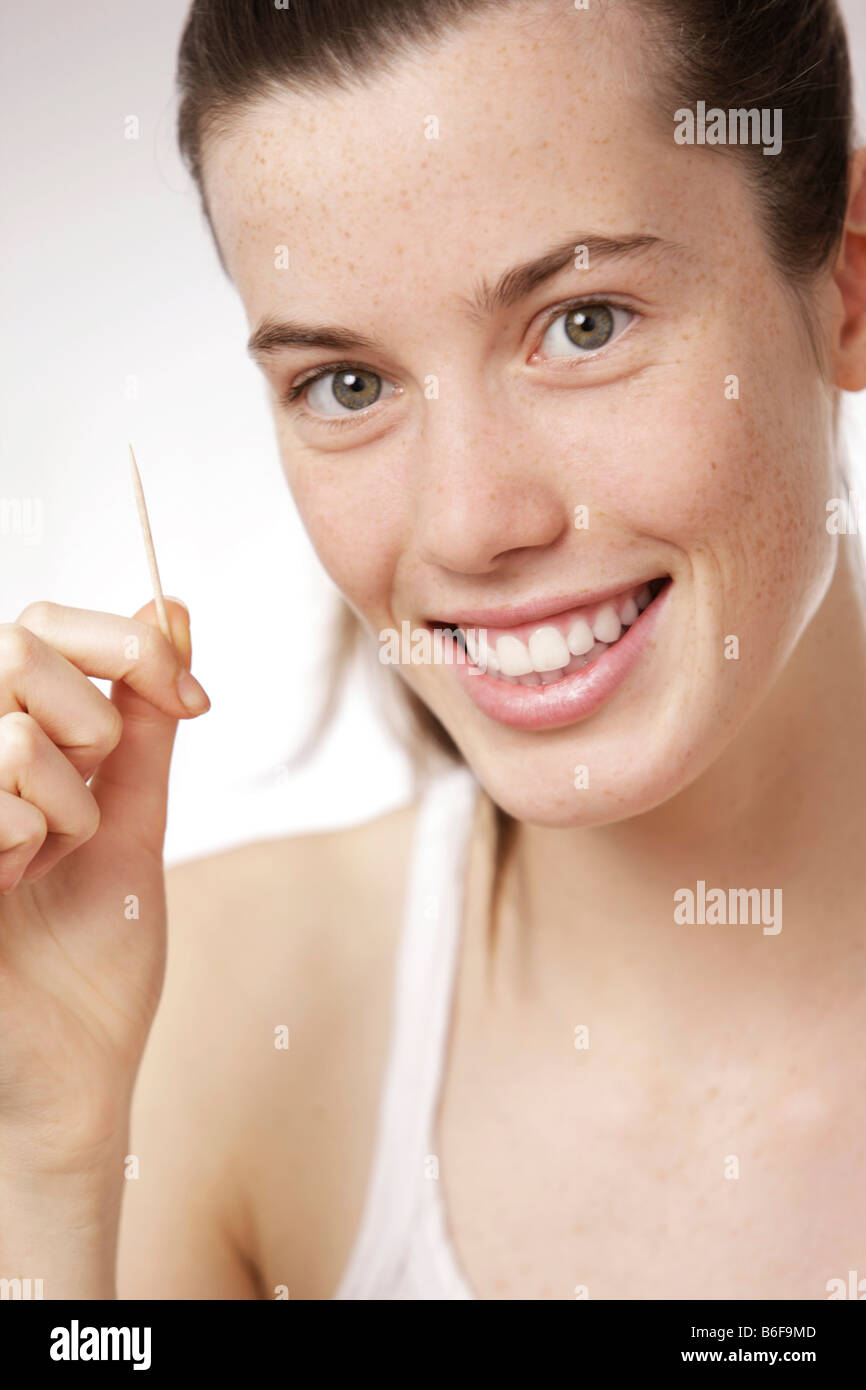 Teenage girl, woman, holding a toothpick Stock Photo - Alamy