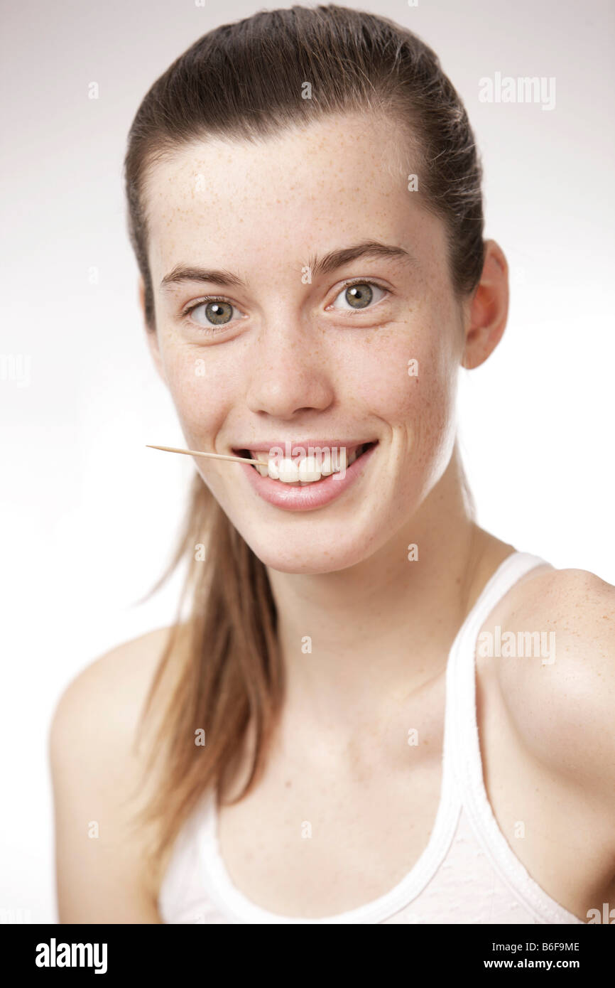 Teenage girl, woman, holding a toothpick between her teeth Stock Photo ...