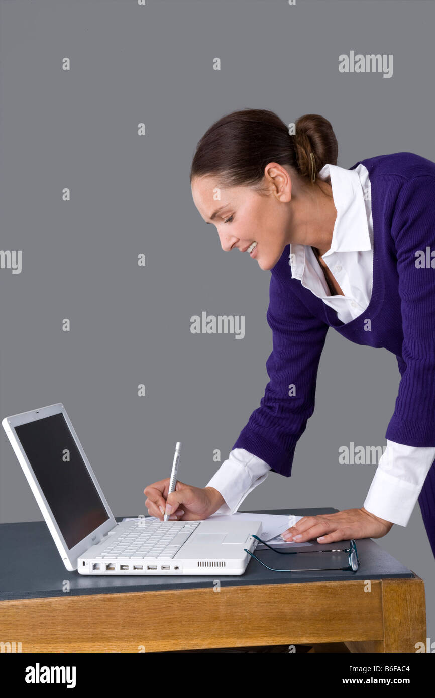 Young woman taking notes Stock Photo - Alamy