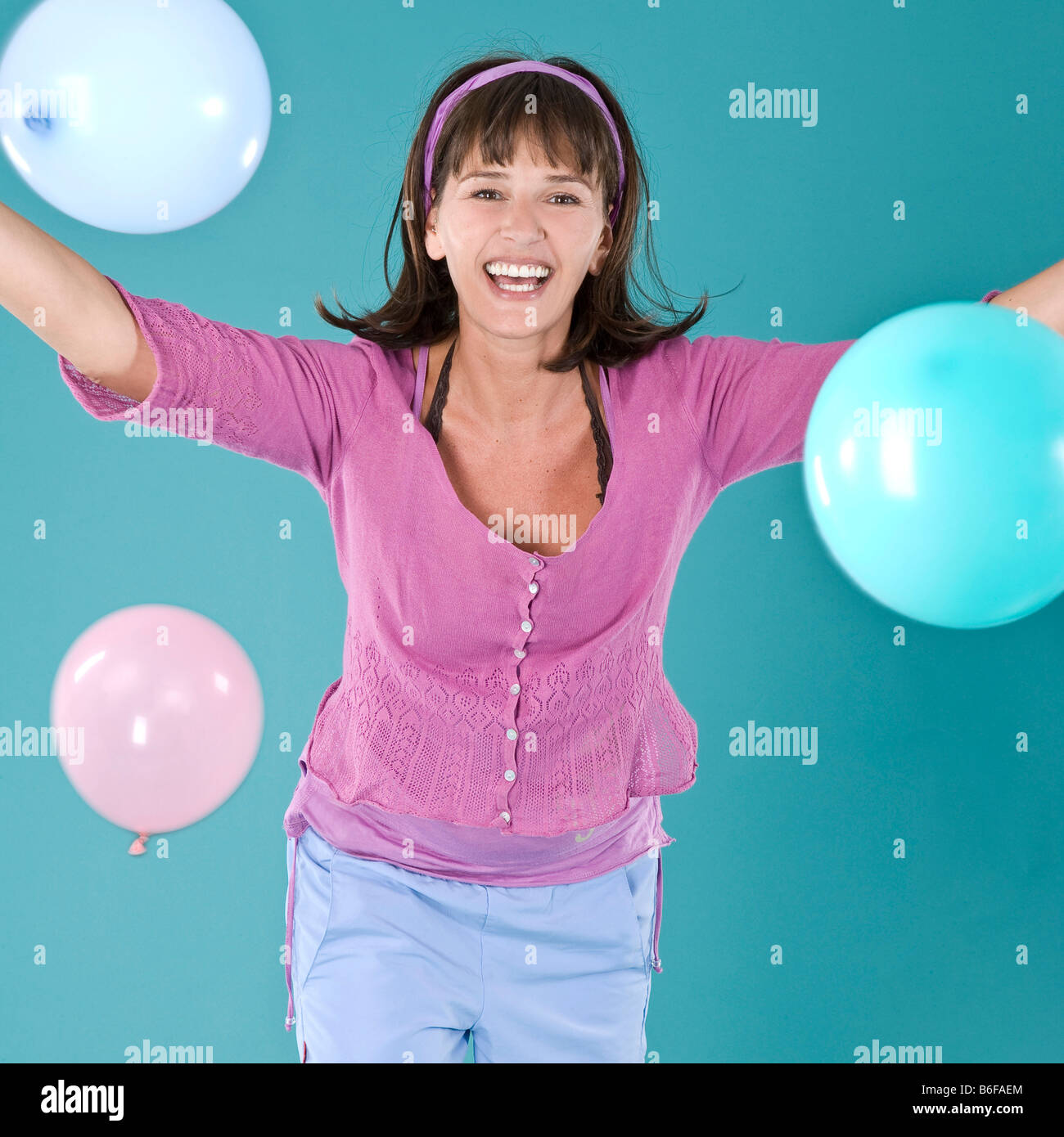 Girl throwing balloons Stock Photo - Alamy