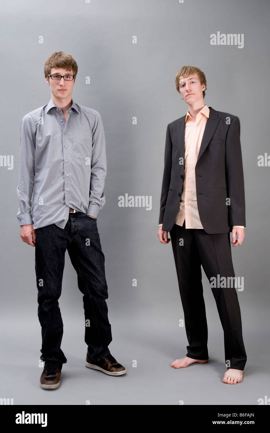 Two boys standing in front of a gray wall Stock Photo - Alamy