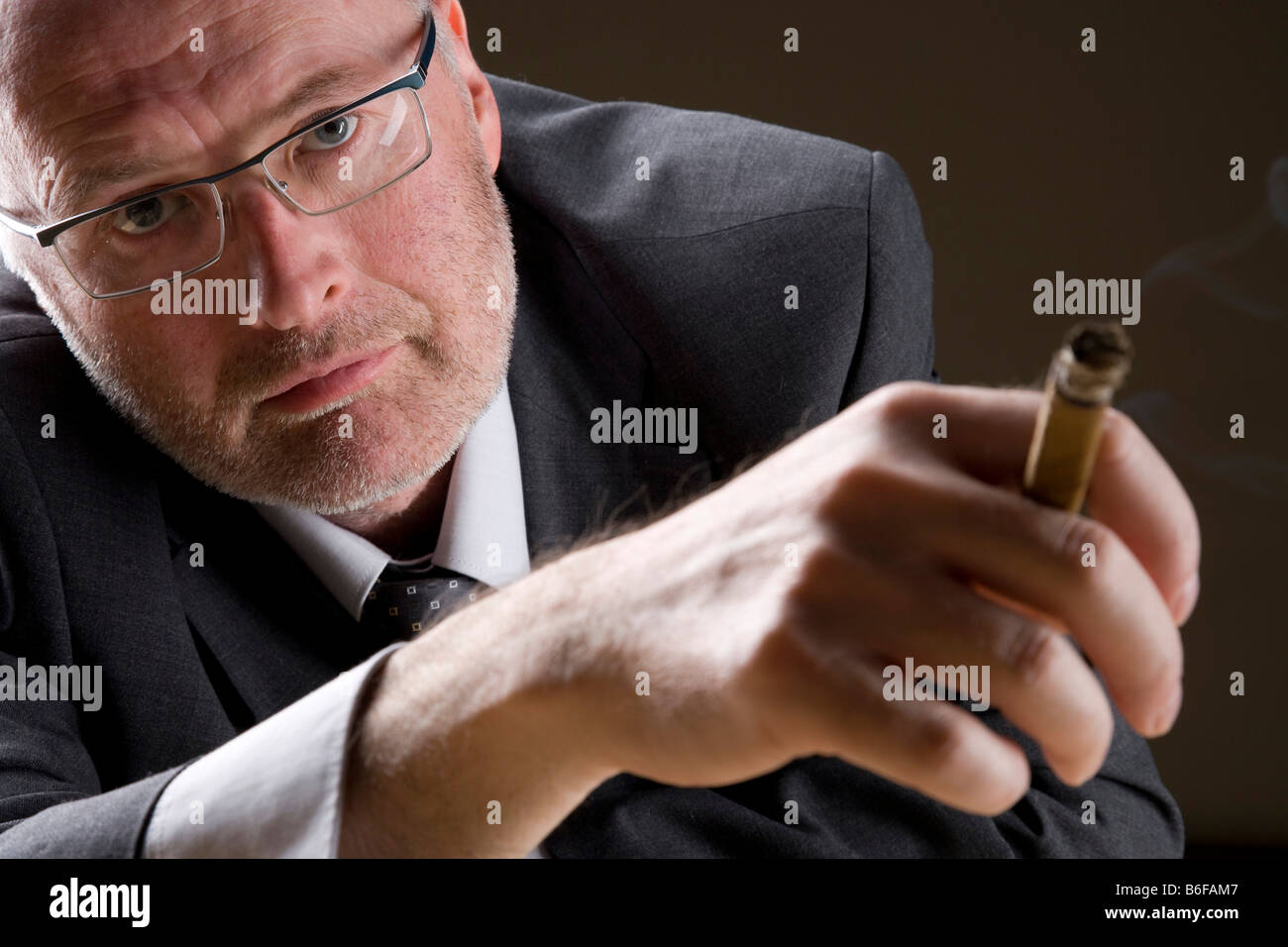 Businessman with a cigar Stock Photo - Alamy