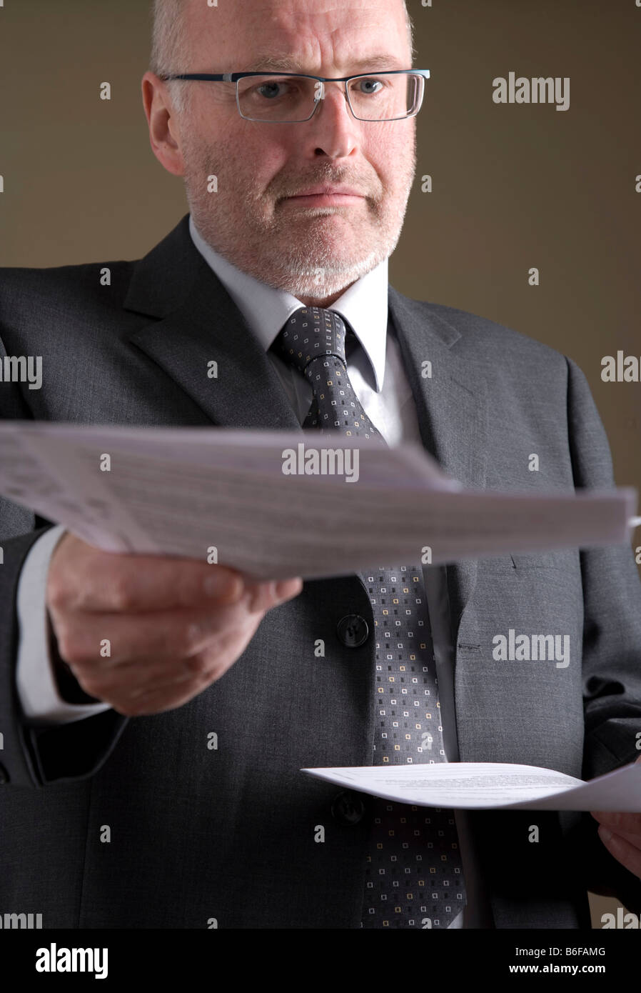 Businessman giving out papers Stock Photo - Alamy