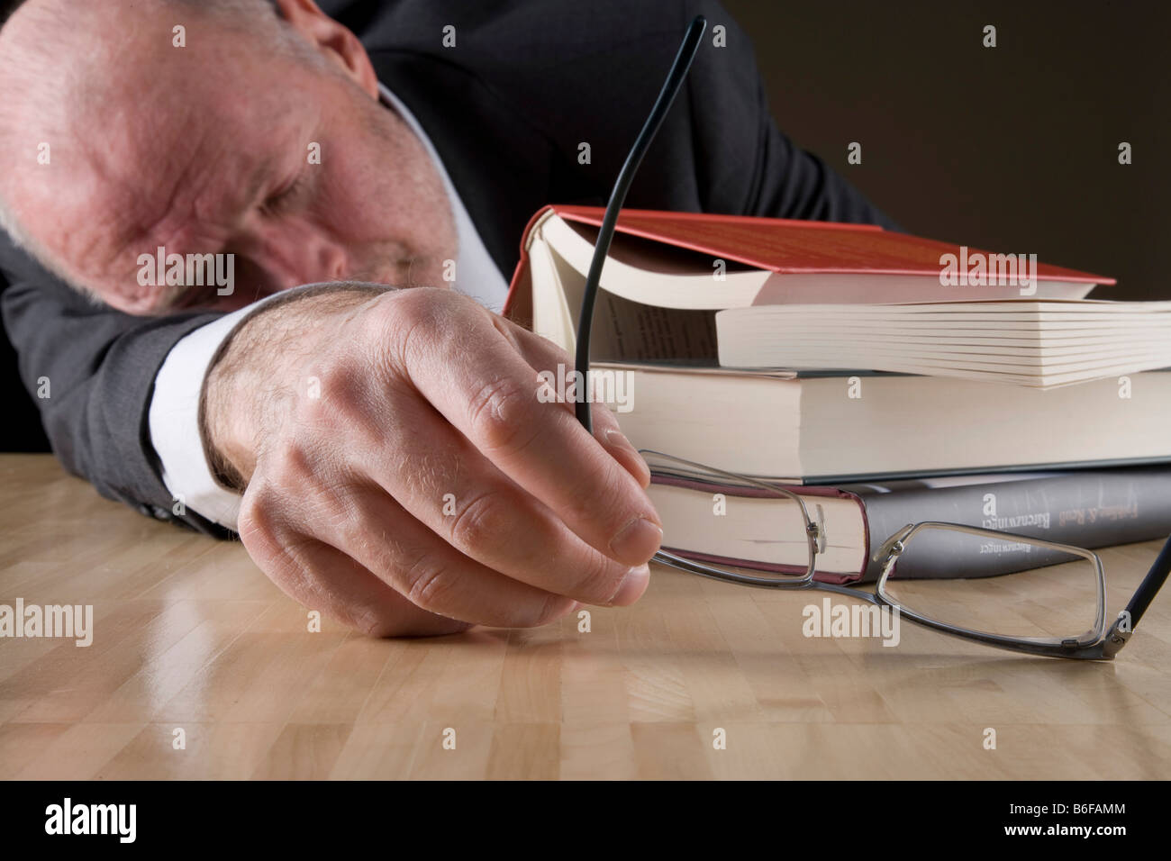 Exhausted businessman with his glasses in his hand, resting Stock Photo ...