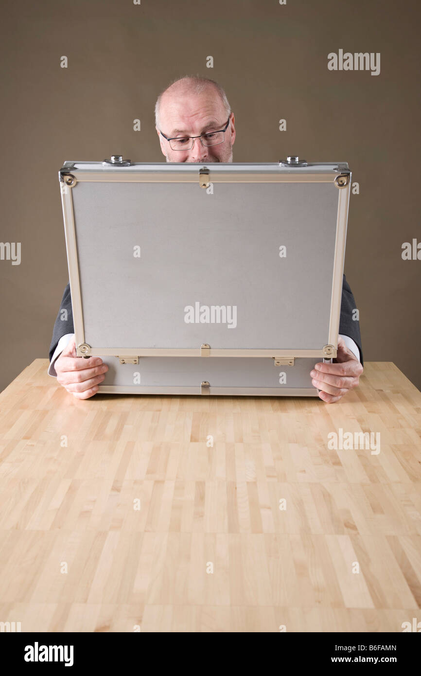 Old man with suitcase full of money hi-res stock photography and images ...