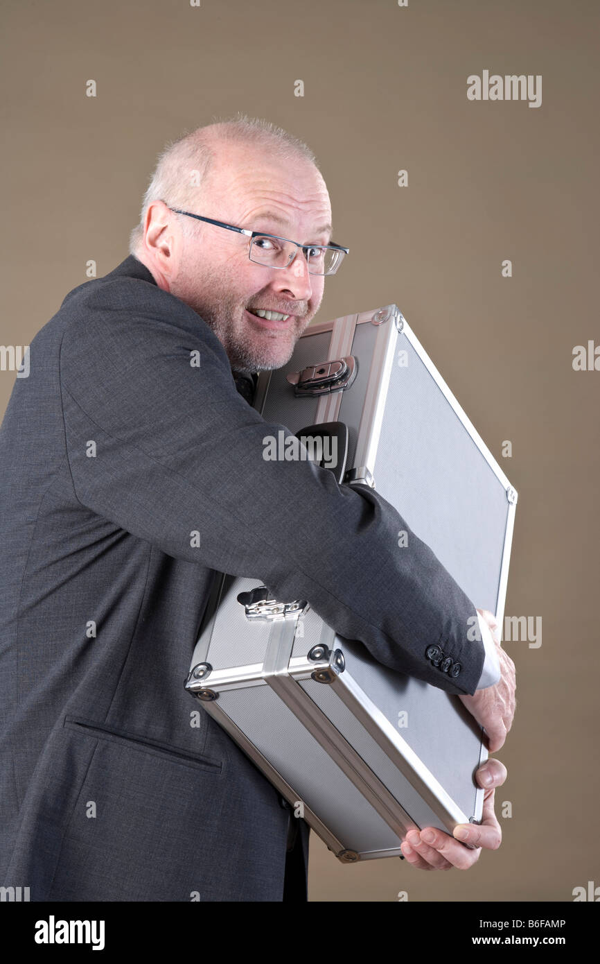 Old man with suitcase full of money hi-res stock photography and images ...